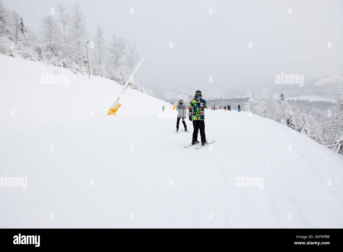 BUKOVEL, UKRAINE - DECEMBER 25: The skiers and snowborders are on slope ...