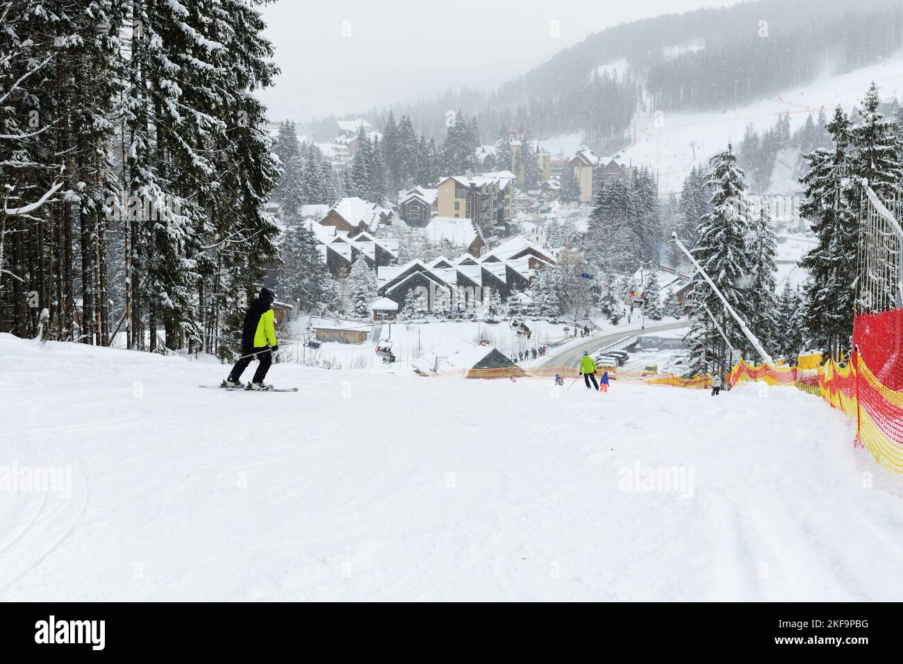 BUKOVEL, UKRAINE - DECEMBER 25: The skiers and snowborders are on slope ...