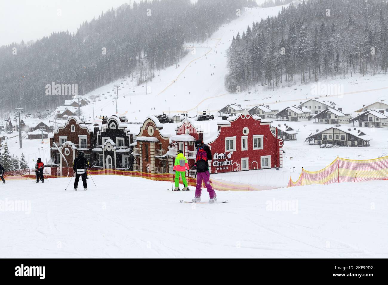 BUKOVEL, UKRAINE - DECEMBER 25: The skiers and snowborders are on slope ...