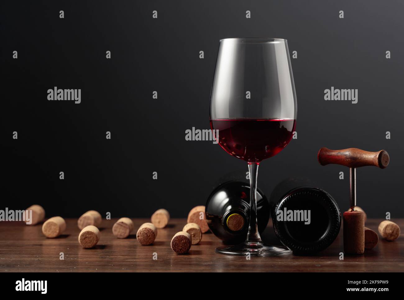 Red wine and wine corks on a wooden table. Copy space Stock Photo - Alamy