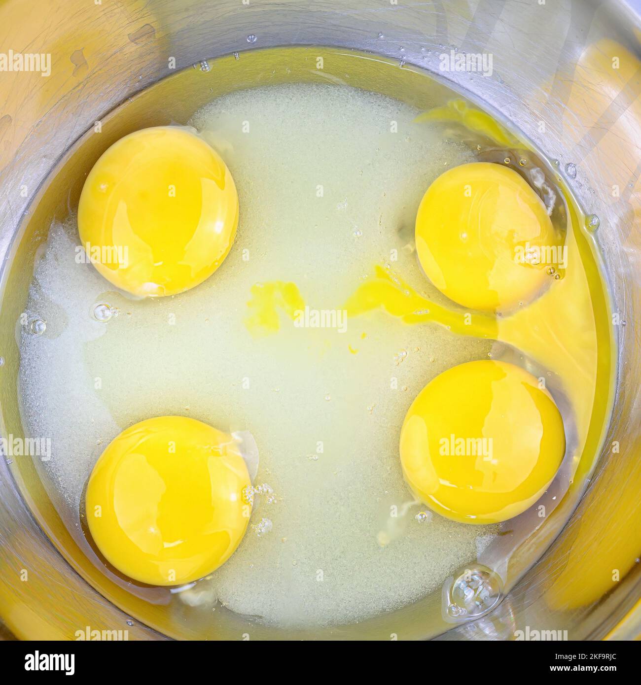 Egg yolk on top of sugar, real-life baking Stock Photo - Alamy