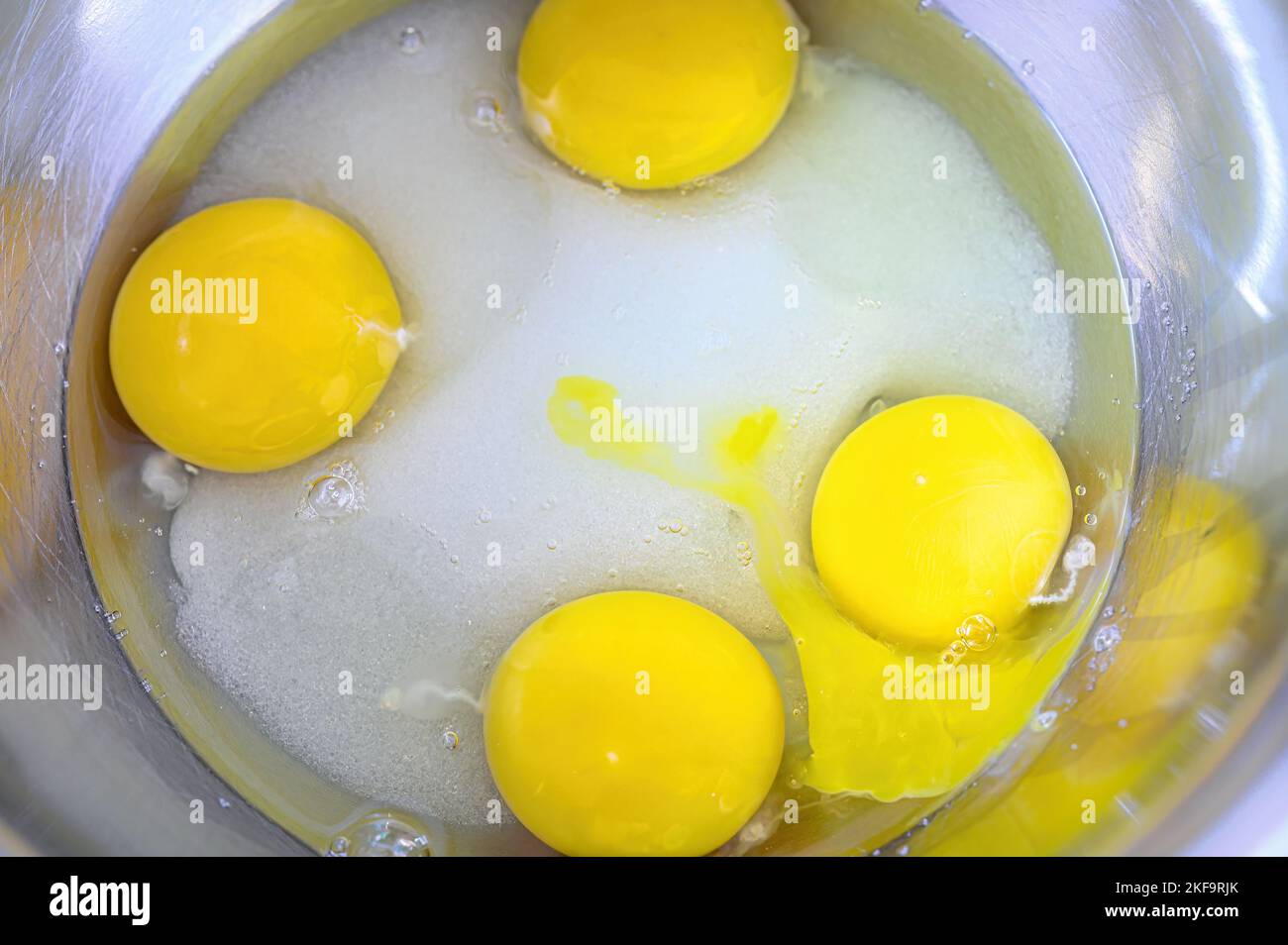 Egg yolk on top of sugar, real-life baking Stock Photo - Alamy