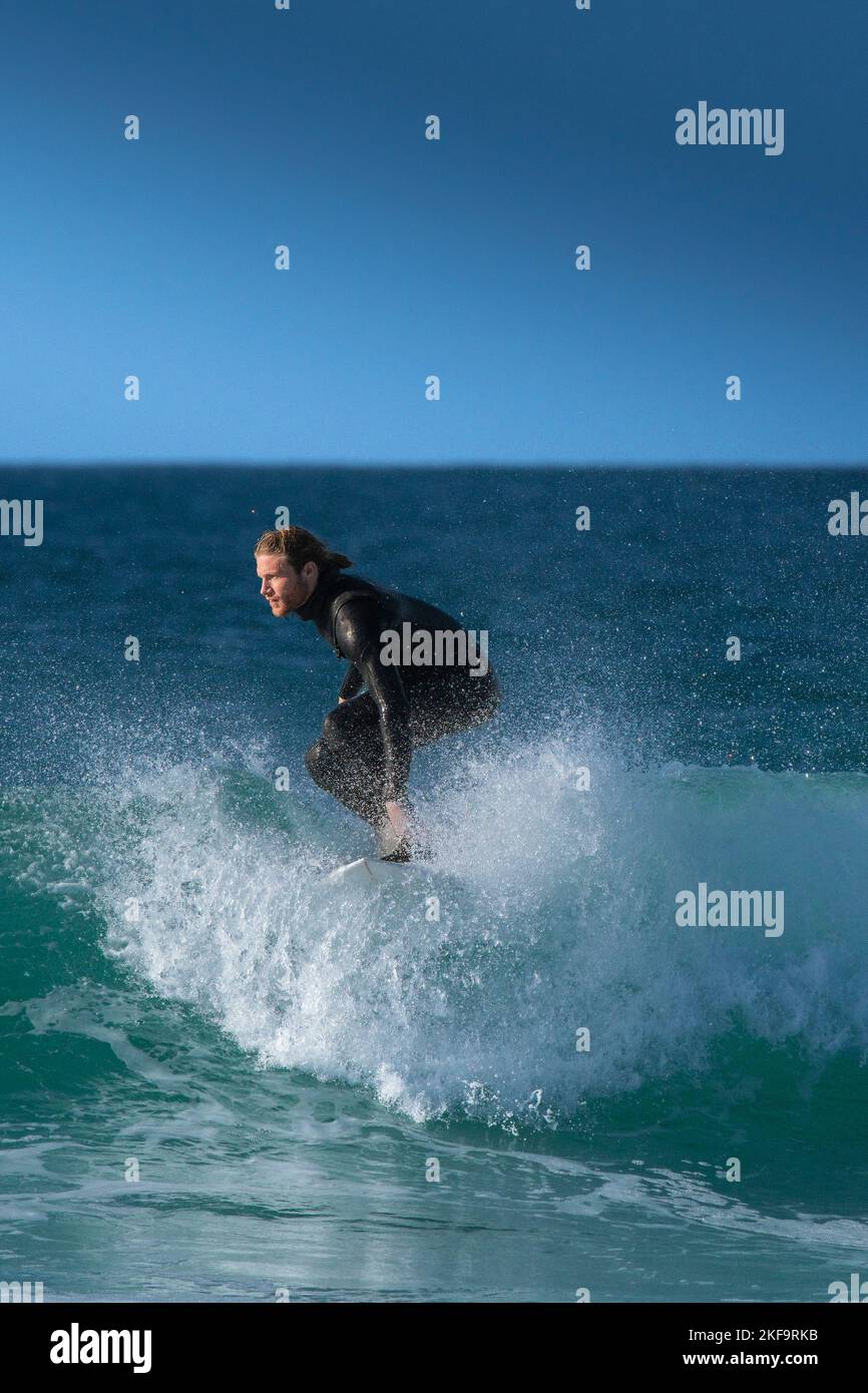 Spectaular surfing action as a male surfer rides a wave at Fistral in ...