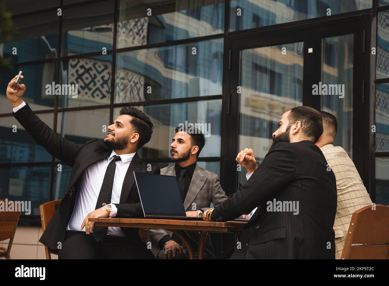 Friends business partners take a selfie at a meeting. An international ...