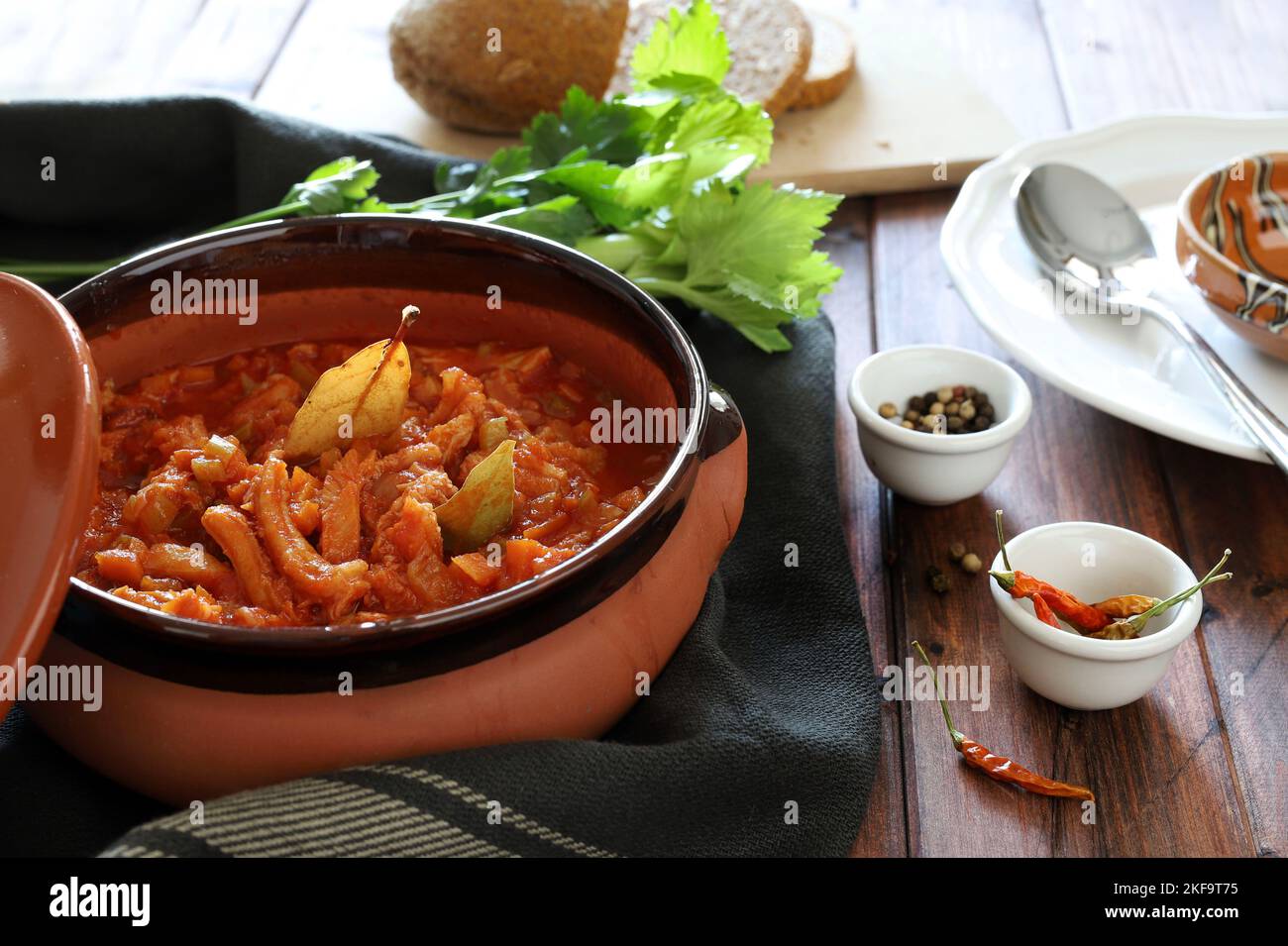 Italian food. Beef tripe with tomato sauce on rustic table. Directly ...
