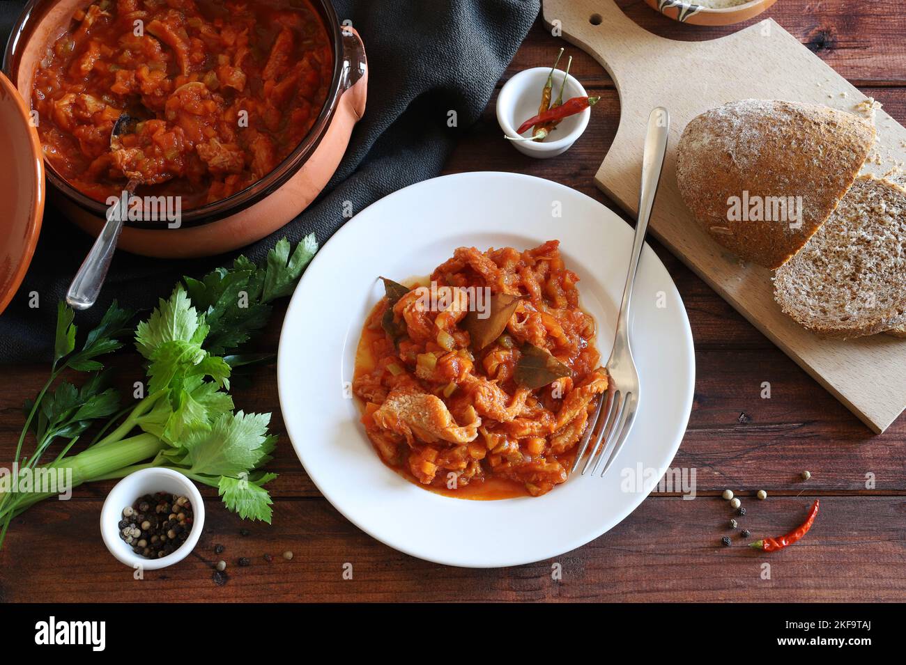 Italian food. Beef tripe with tomato sauce on rustic table. Directly ...