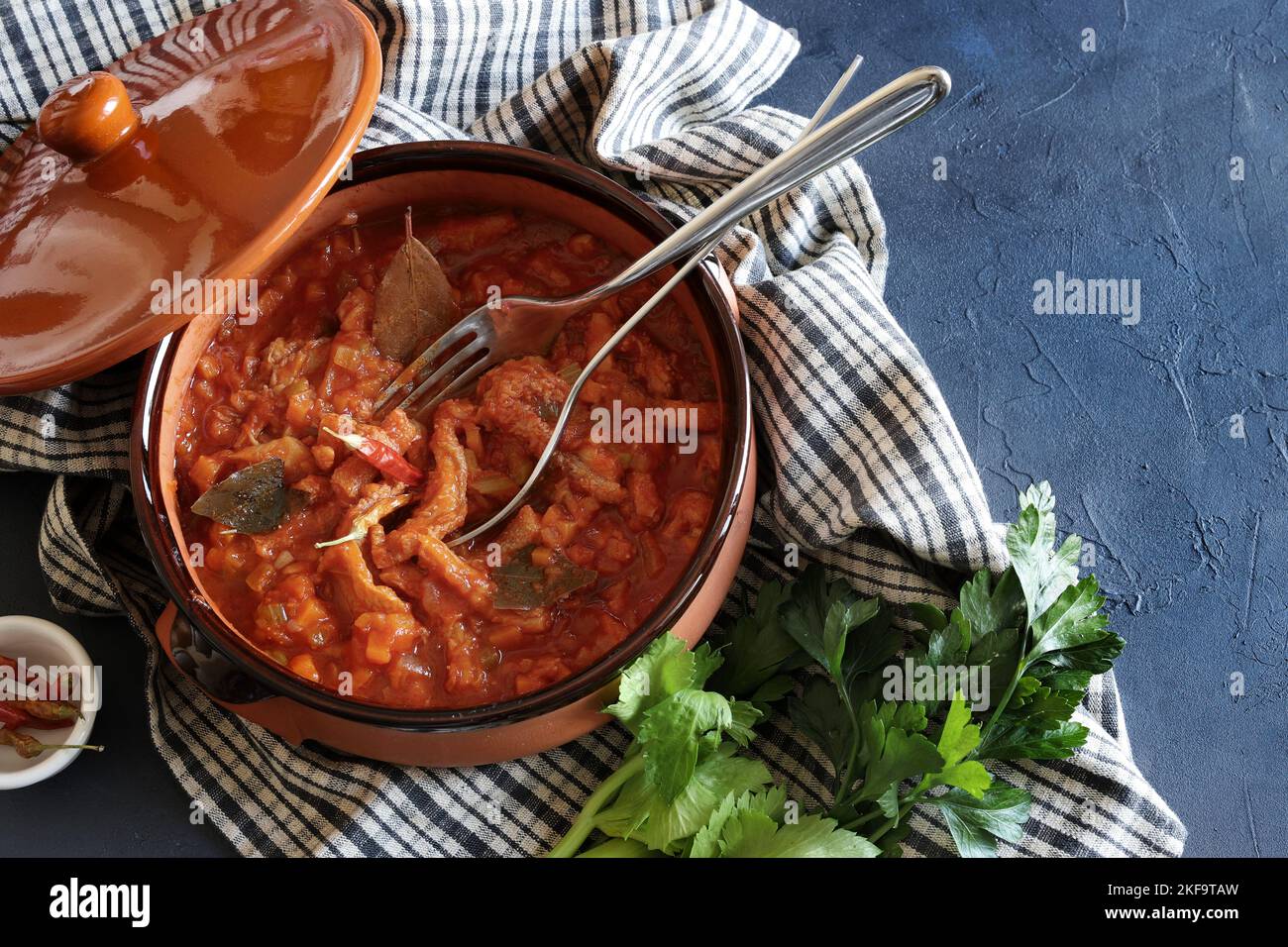 Italian food. Beef tripe with tomato sauce on rustic table. Directly ...