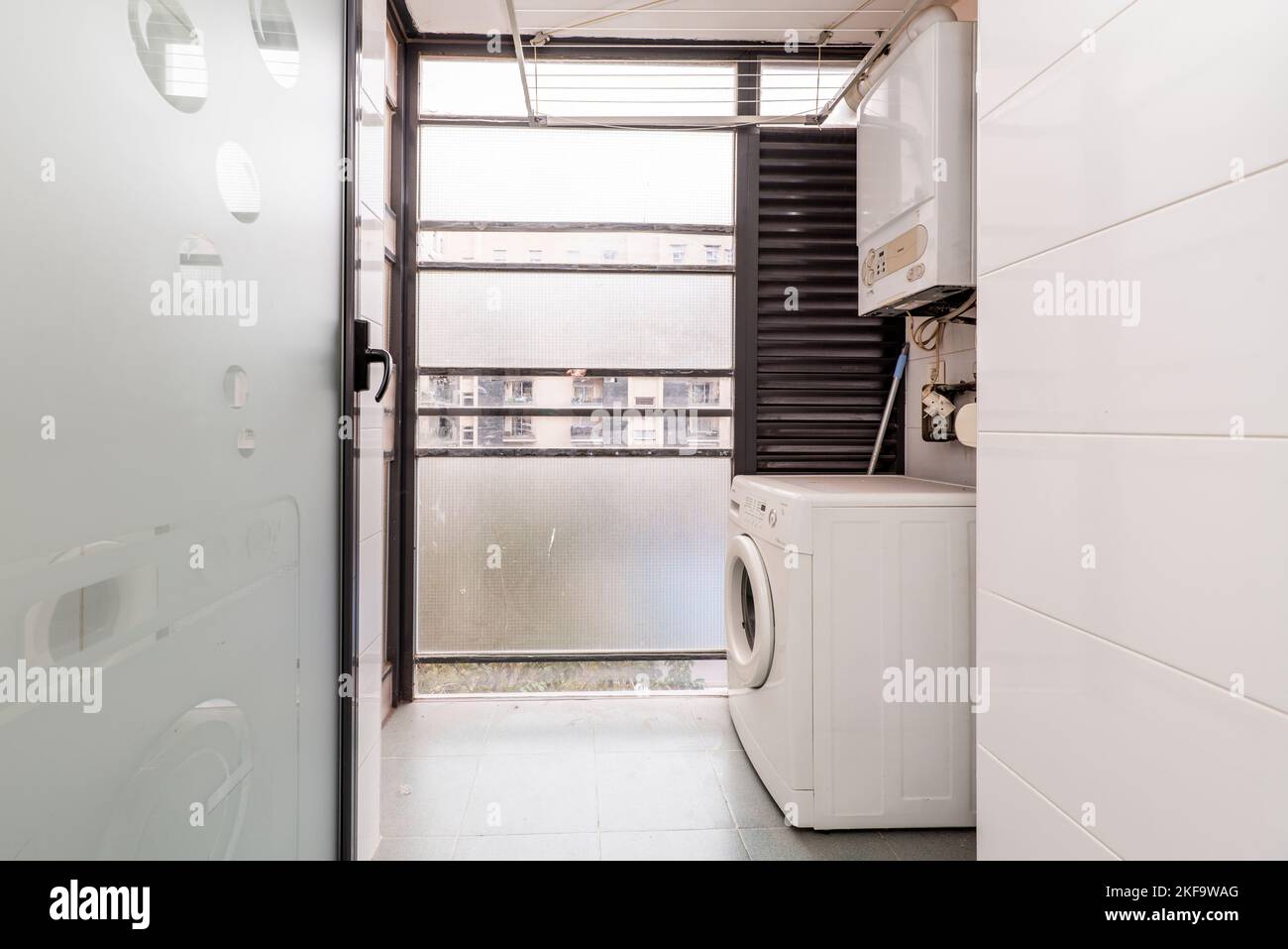 Drying room terrace with glass door and washing machine with heater ...