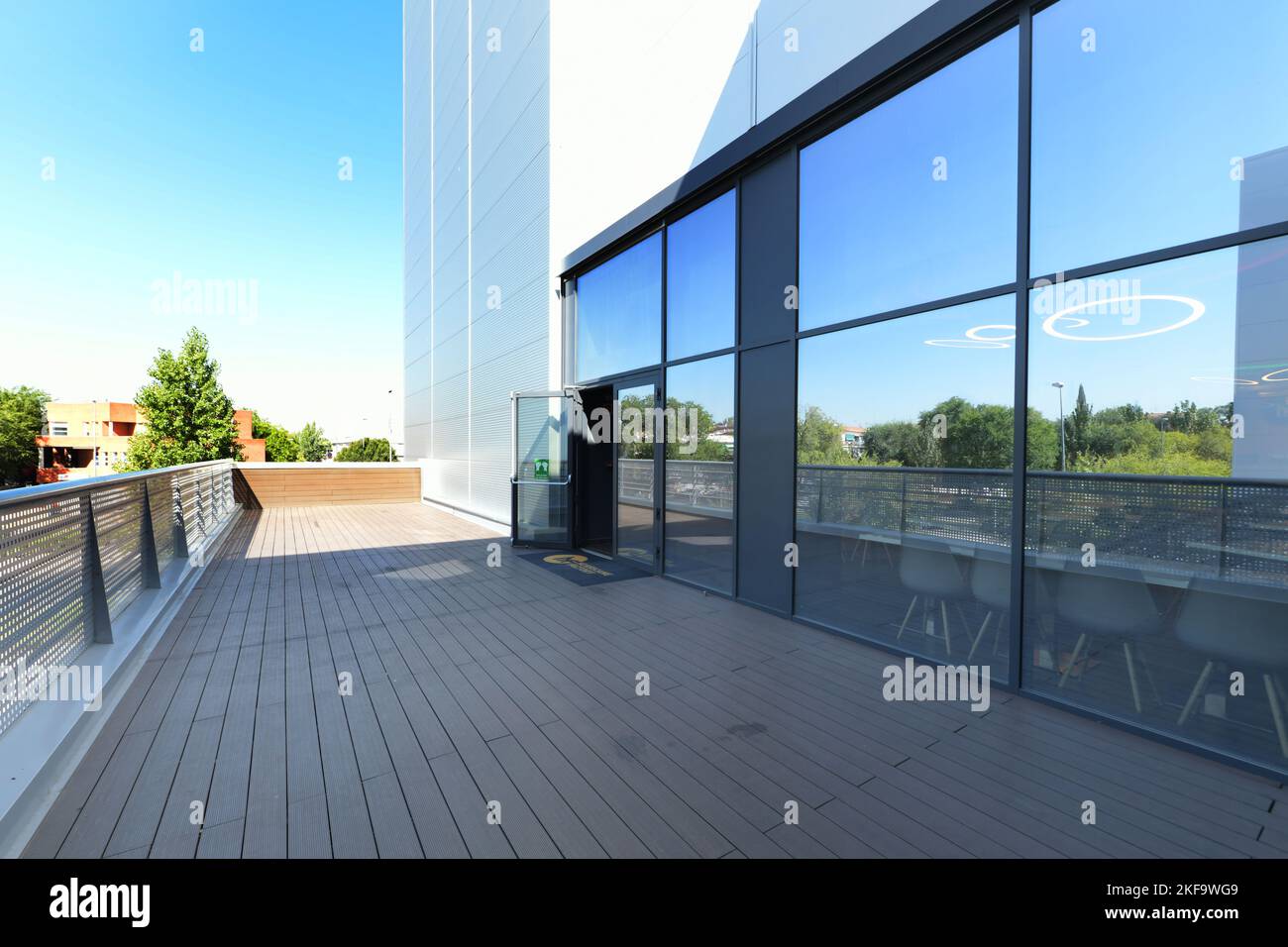 Empty terrace with wooden floors in a local with metal railing and ...
