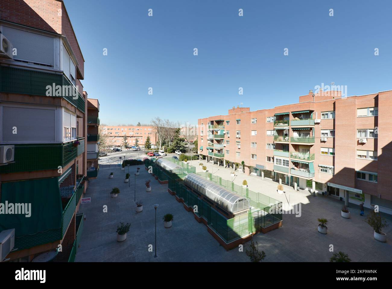 Views of brick building facades and a public square with circular ...