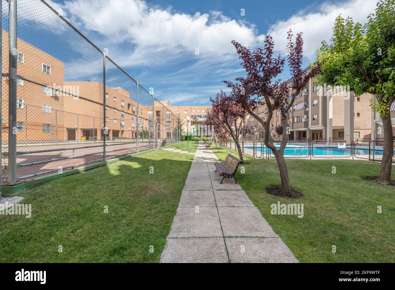 Views of buildings and common areas landscaped with flowers, lawns ...