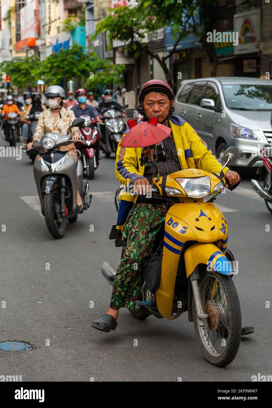 Saigon Street Life. A driver using Google Maps. A rush hour motorcycle ...
