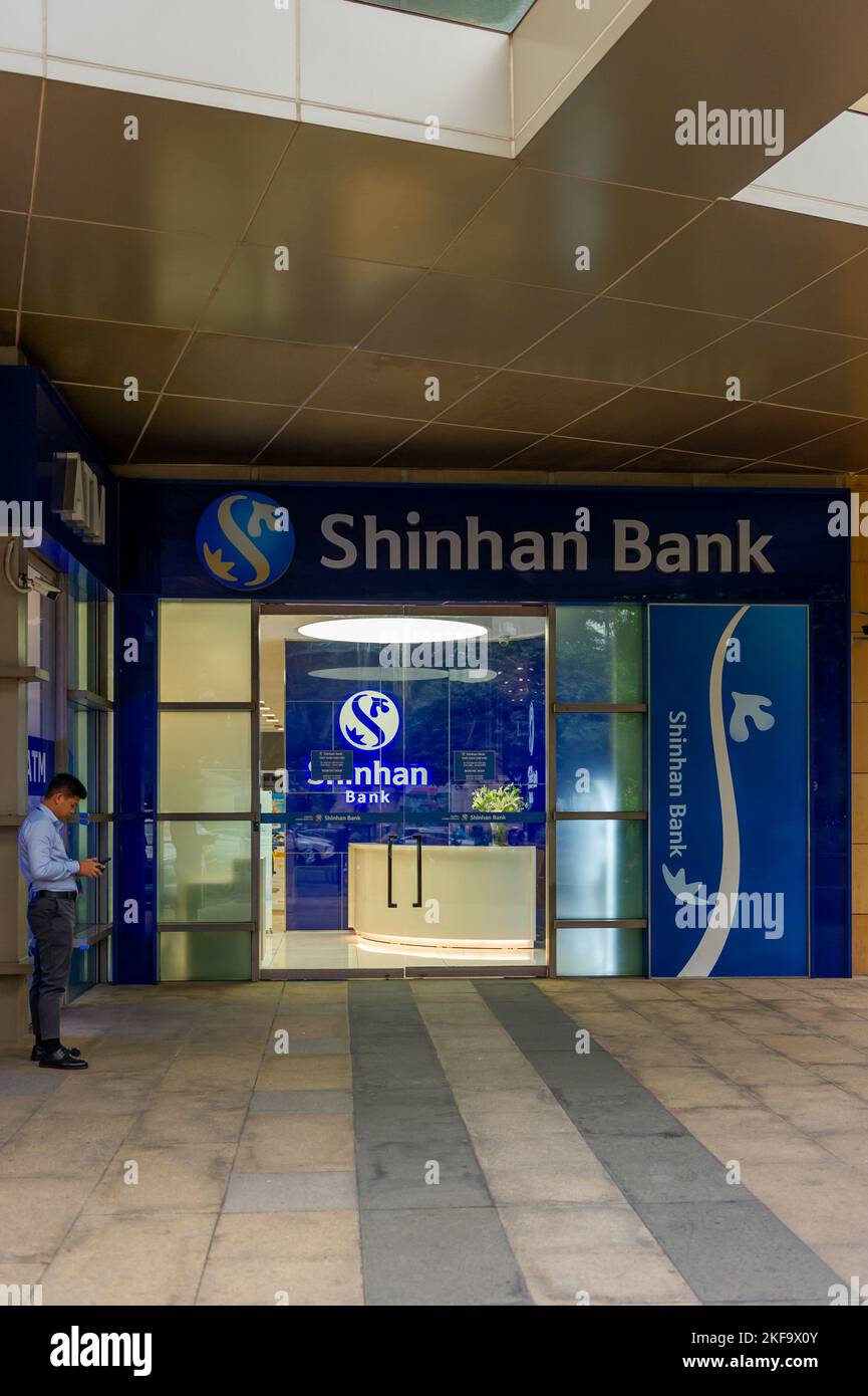 Front view of a Shinan Bank branch with a customer standing outside, Ho ...