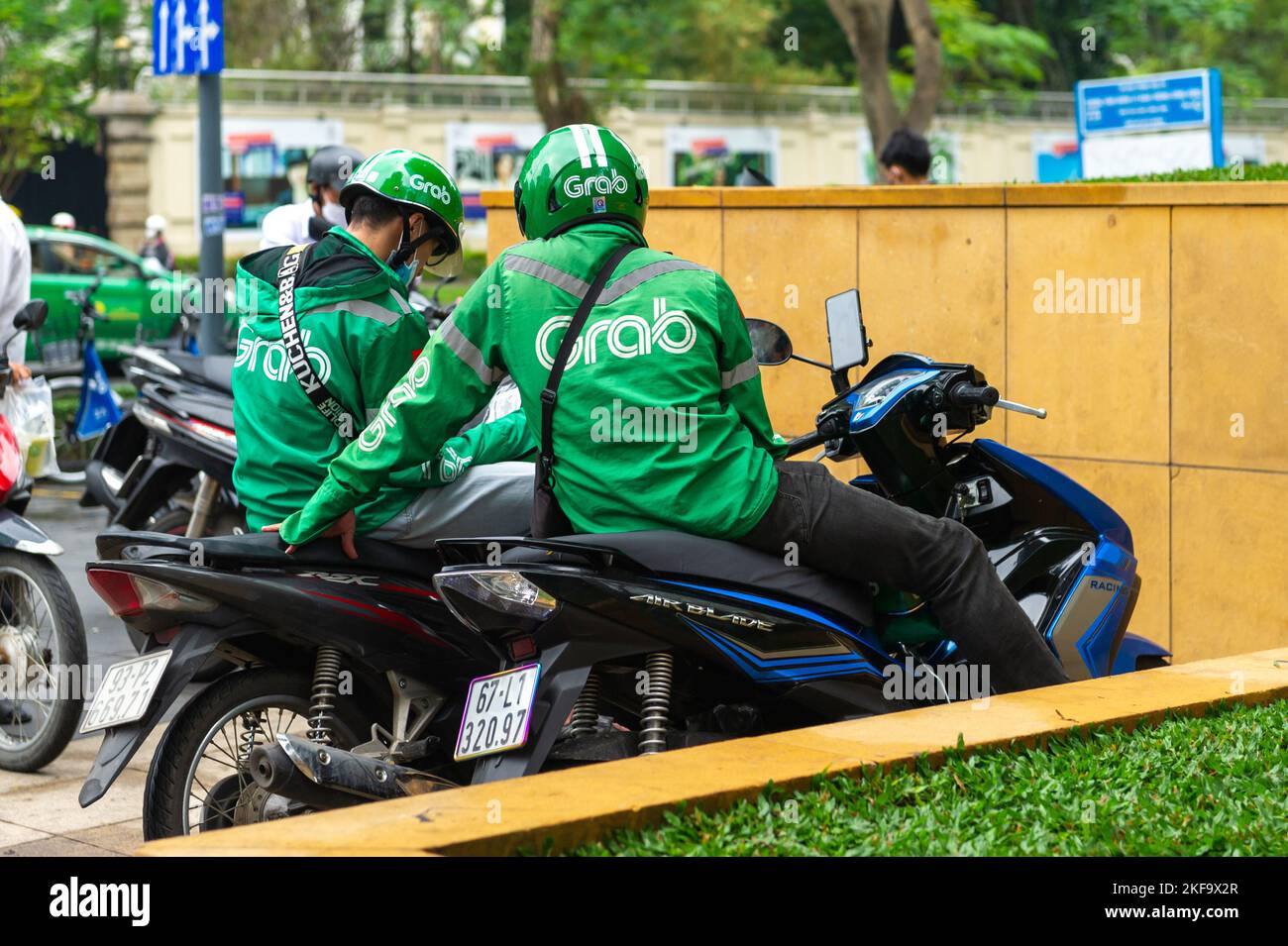 Grab Bike Riders taking a break in Ho Chi Minh City, Vietnam Stock Photo - Alamy