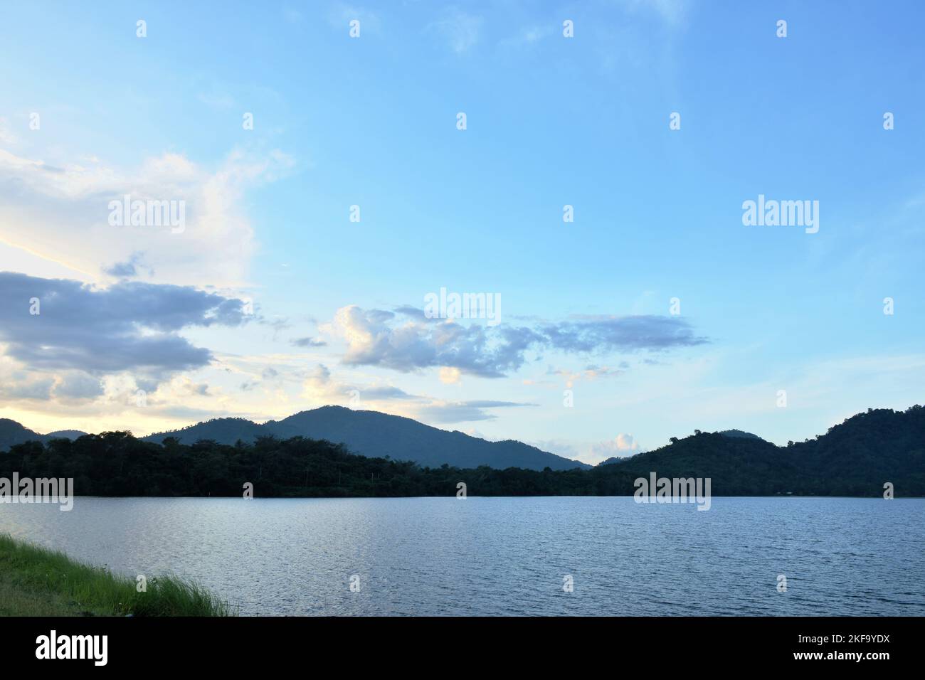 landscape of water reservoir lake with mountain background in sunset ...