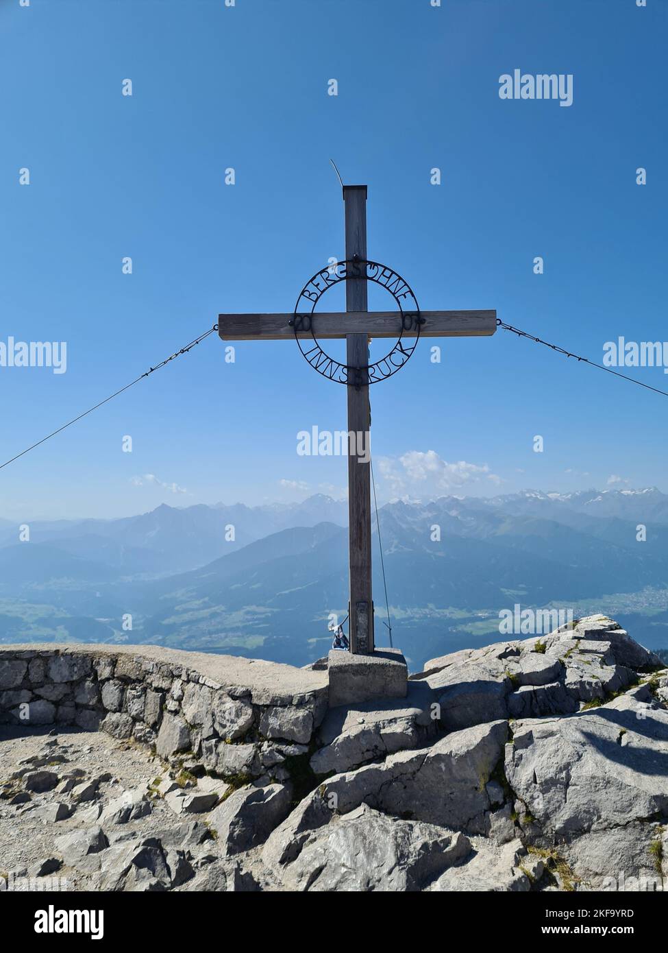 A vertical shot of a cross on the rocks on Hafelekarspitze mountain ...