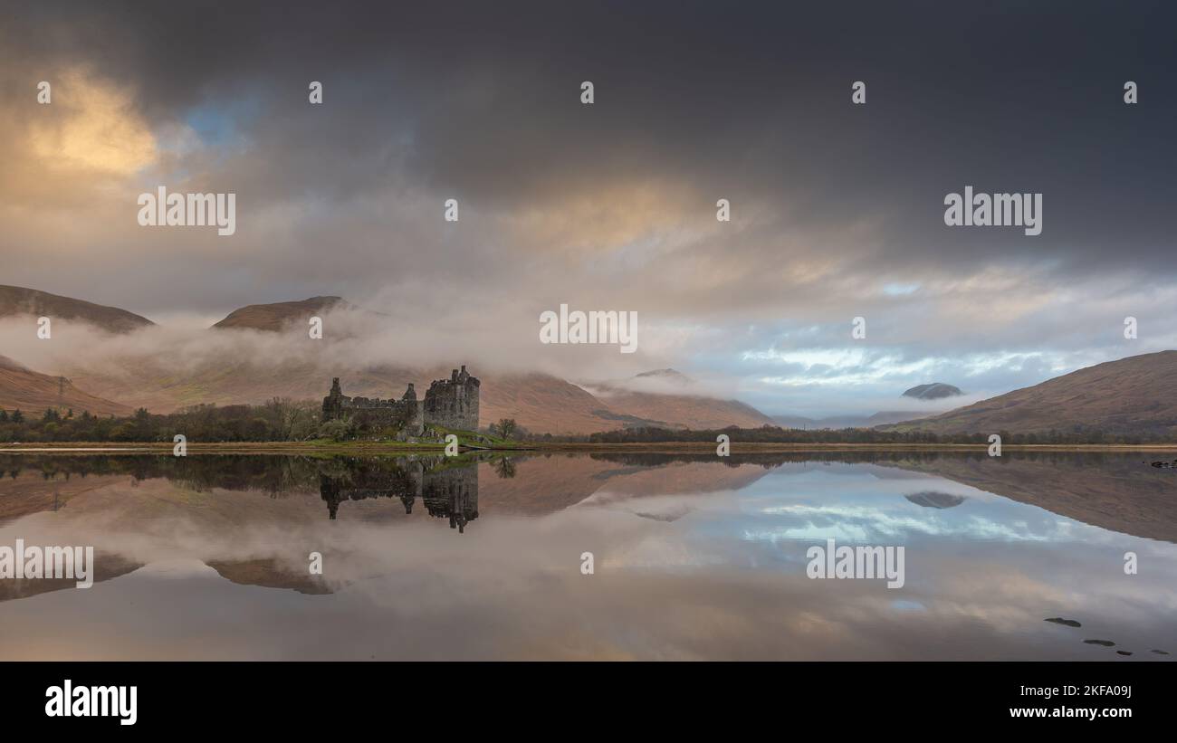 Scottish castle by the side of the loch. Beautiful reflection of the ...
