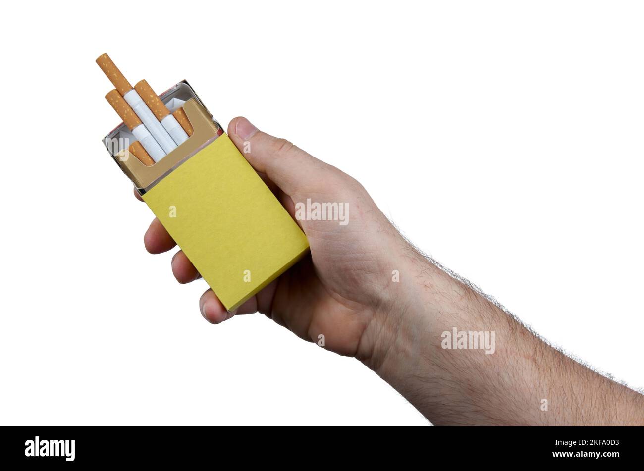 Close-up of a human hand holding a yellow pack of cigarettes isolated ...
