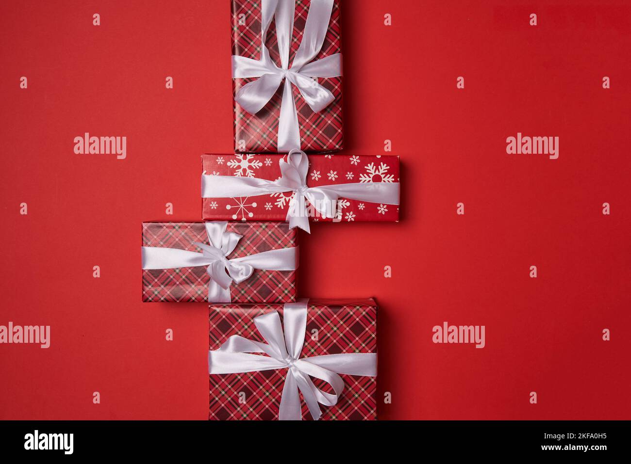 Red gift boxes with white ribbon on red background. Concept of ...