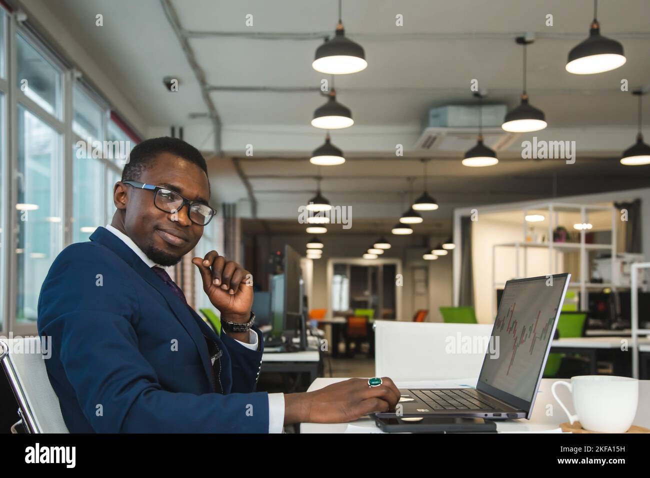 A black African American businessman in a business suit works at a ...