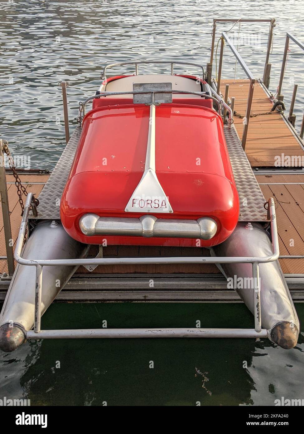 A vertical shot of paddle boats near the port in Lugano Lake ...