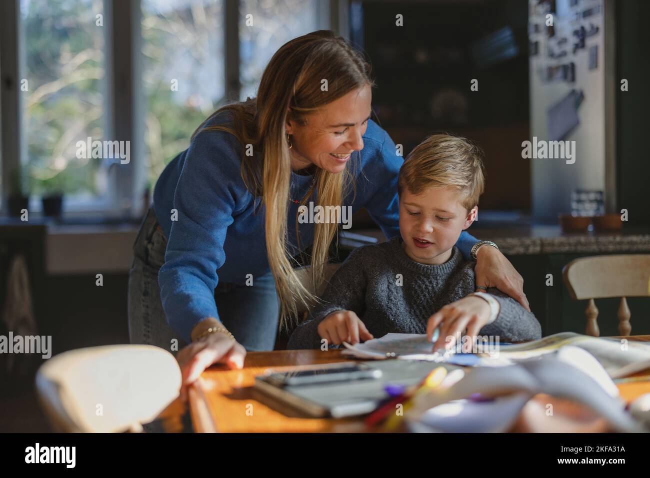 Mother helping son with homework at home Stock Photo - Alamy