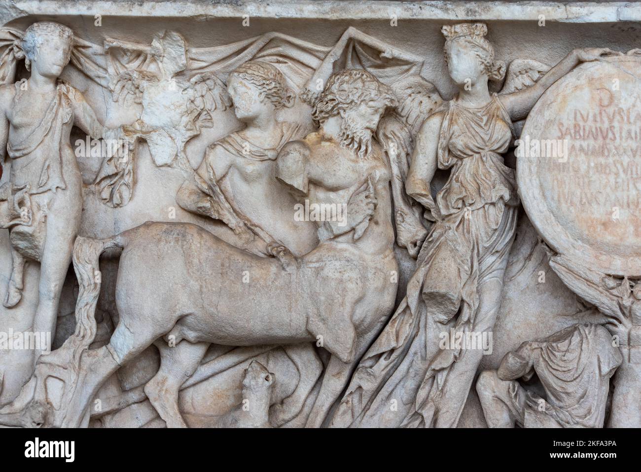 Close-up on ruins of engraved sculptures in marble wall representing a ...