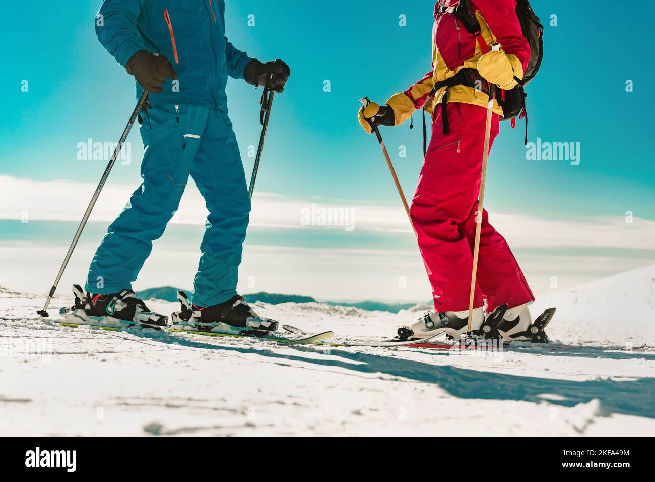 Two skiers stands on mountain top. Close up photo of legs Stock Photo ...