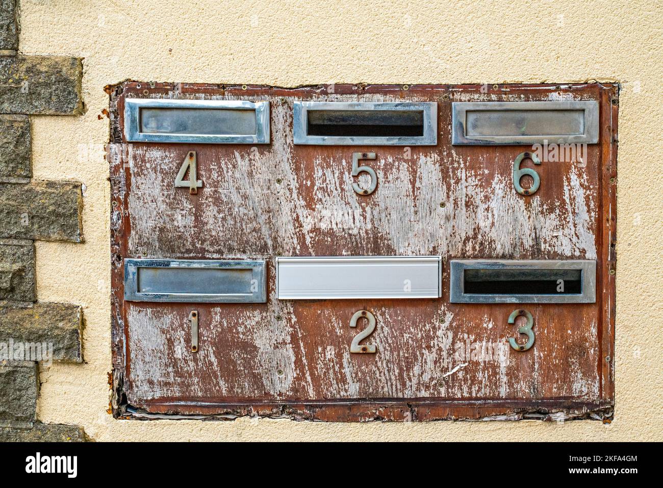 Six letterboxes set into wall of building Stock Photo - Alamy