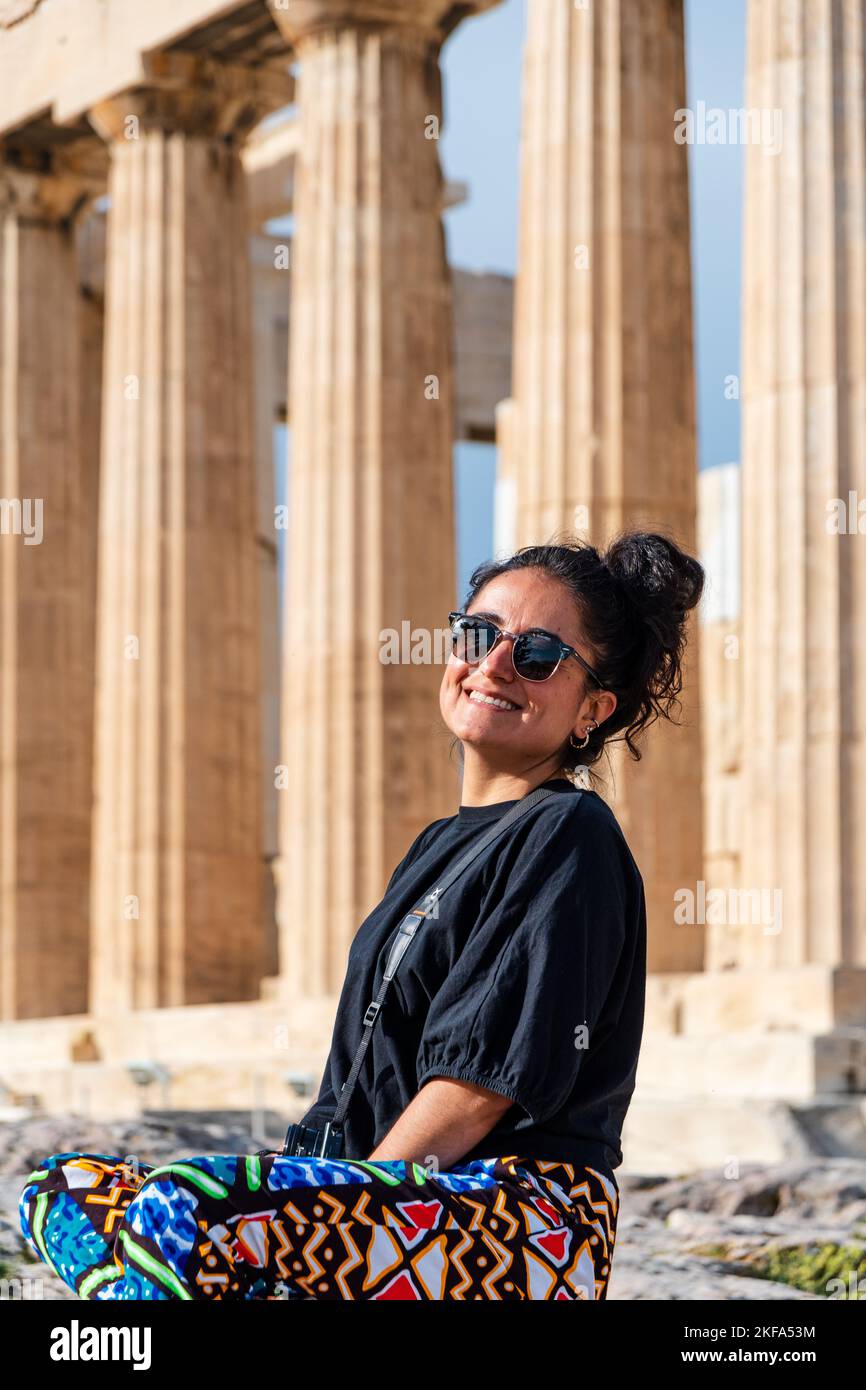 A vertical shot of a female smiling towards the camera at Acropolis ...