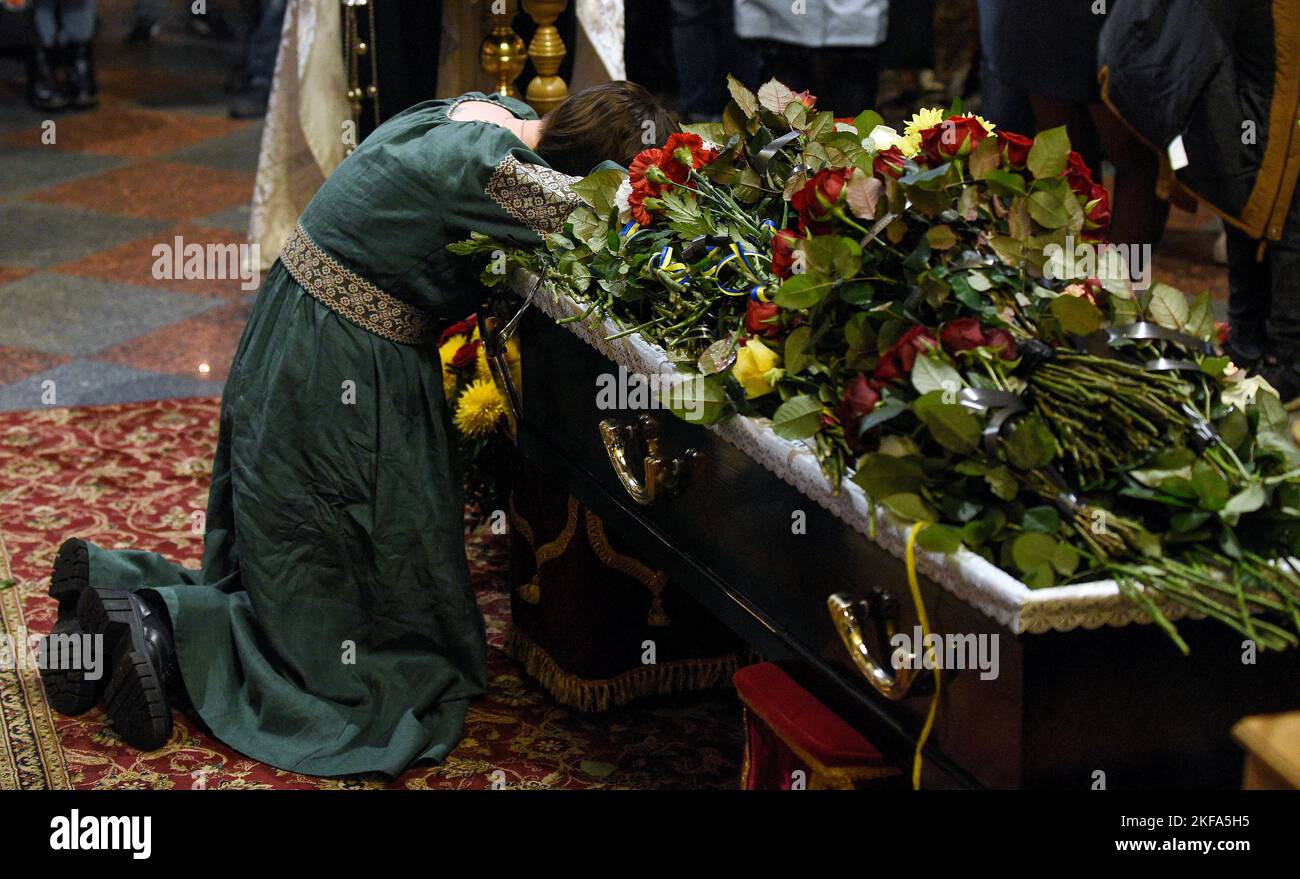 KYIV, UKRAINE - NOVEMBER 16, 2022 - A woman grieves by the coffin with ...