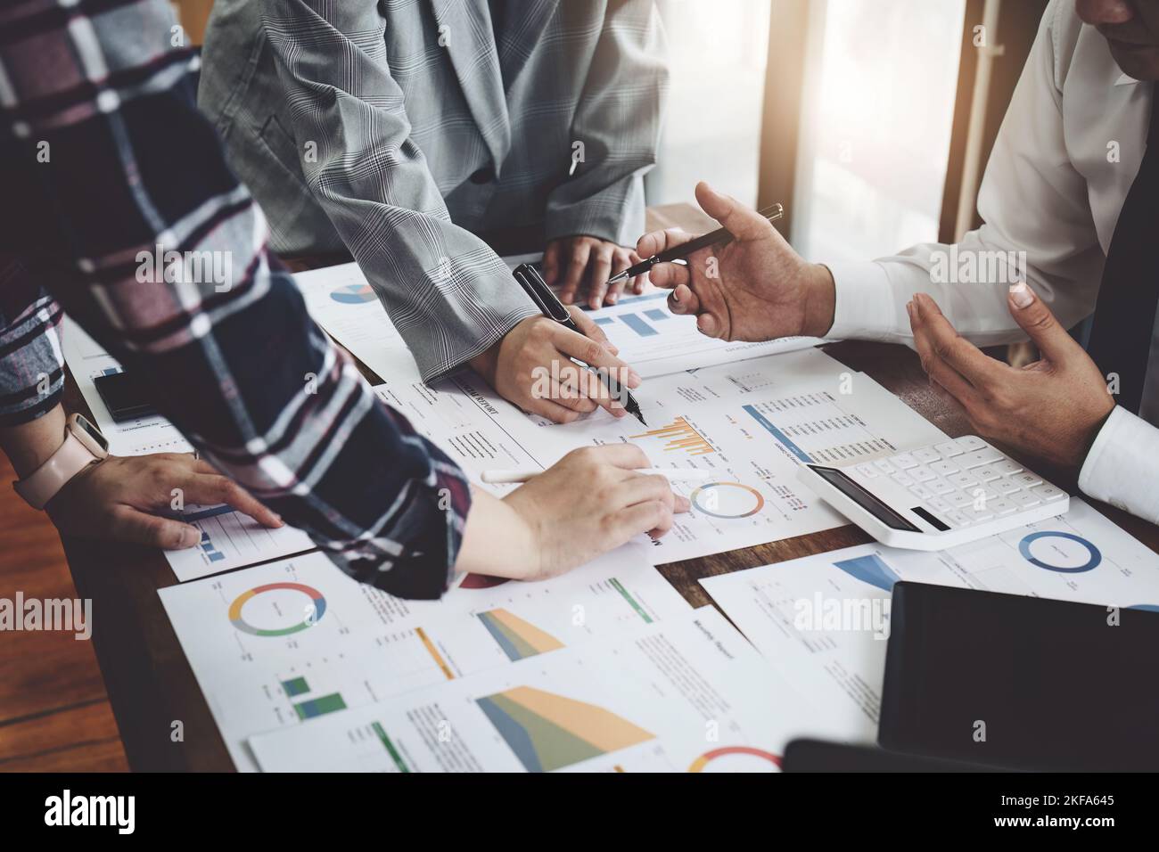 businesspeople working with partners adjusting marketing strategies ...