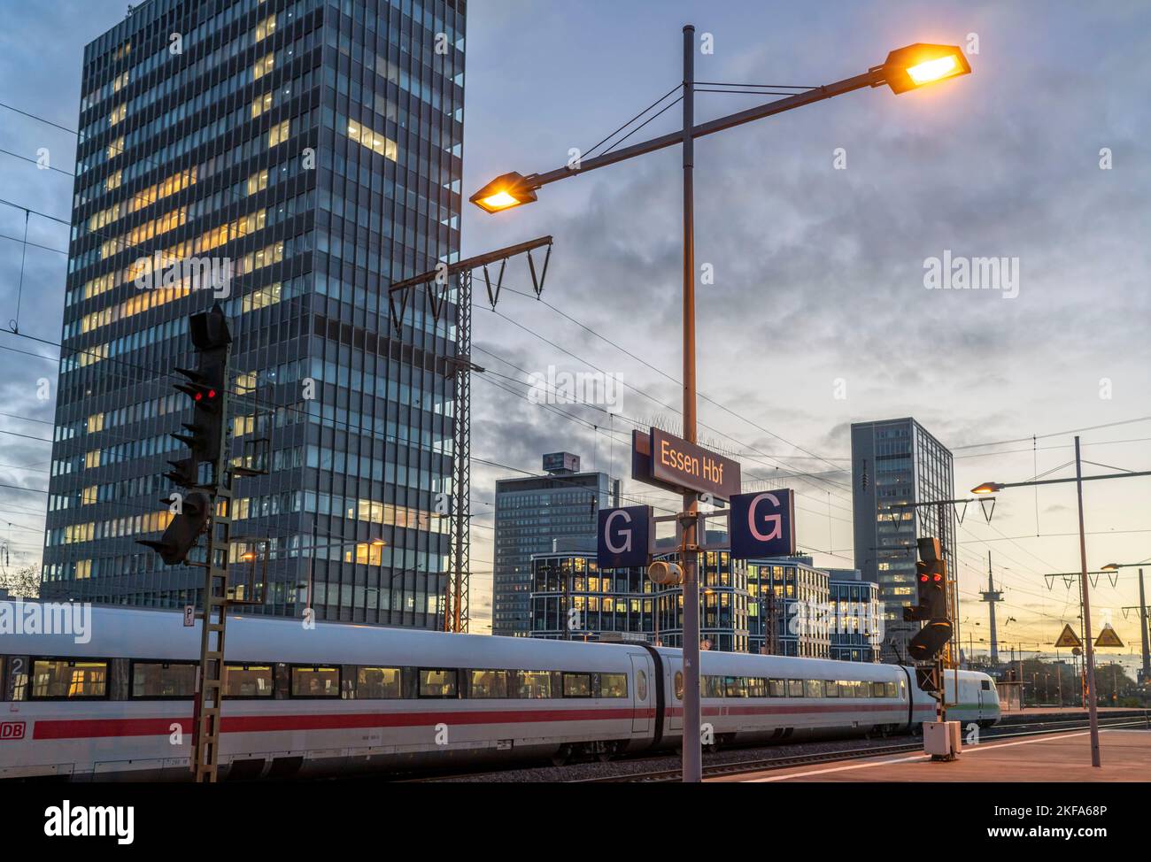 Railway station, ICE train on platform, skyline of Essen city centre ...