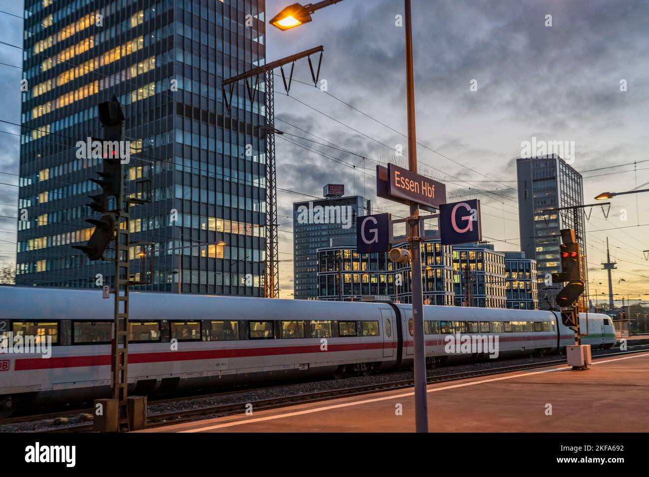 Railway station, ICE train on platform, skyline of Essen city centre ...