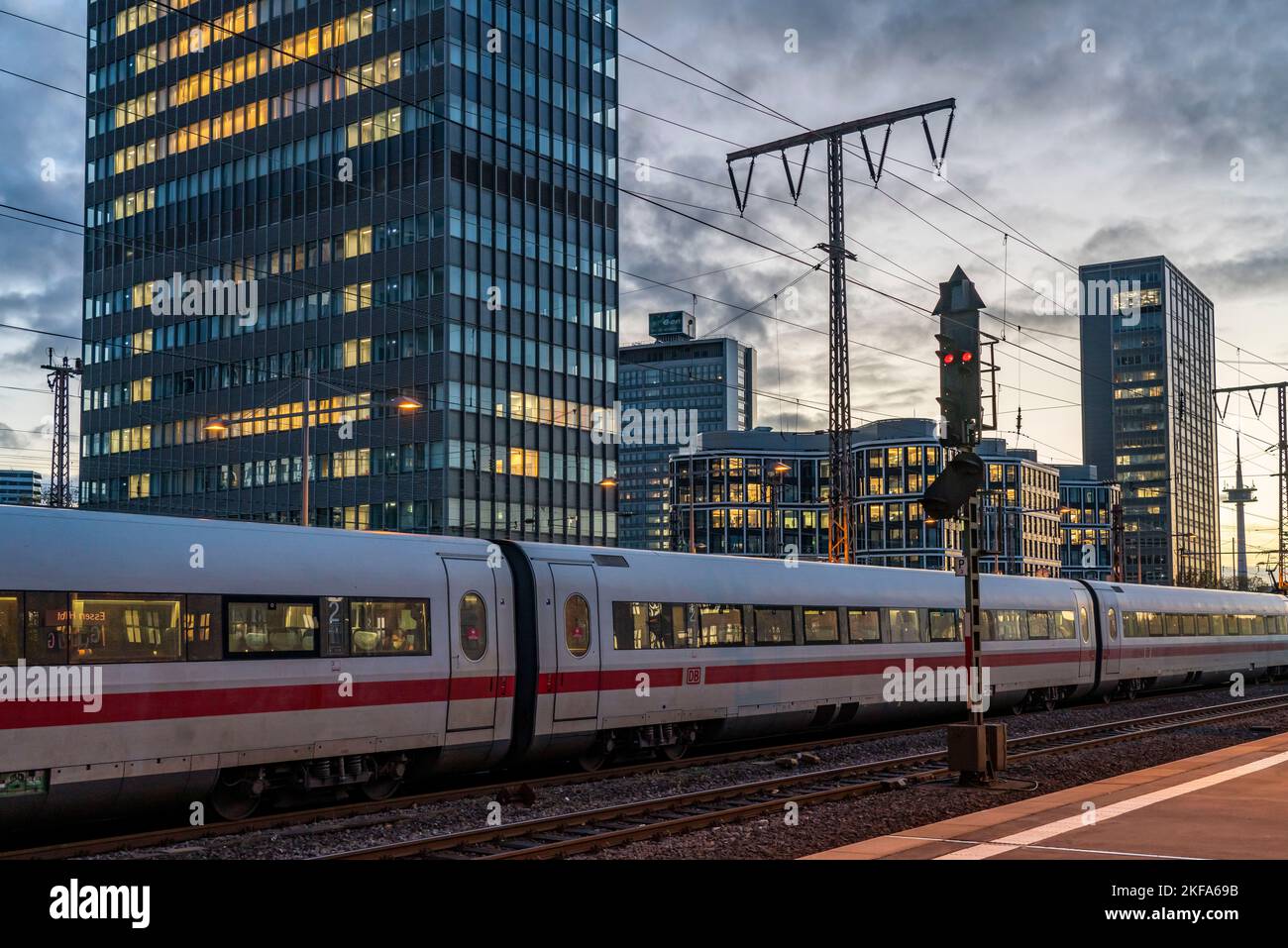 Railway station, ICE train on platform, skyline of Essen city centre ...