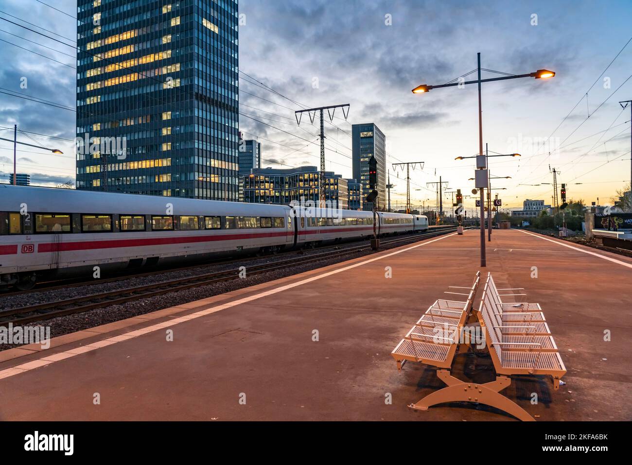 Railway station, ICE train on platform, skyline of Essen city centre ...