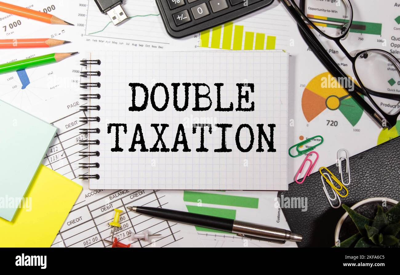 Notepad with text DOUBLE TAXATION. Diagram and white background Stock ...