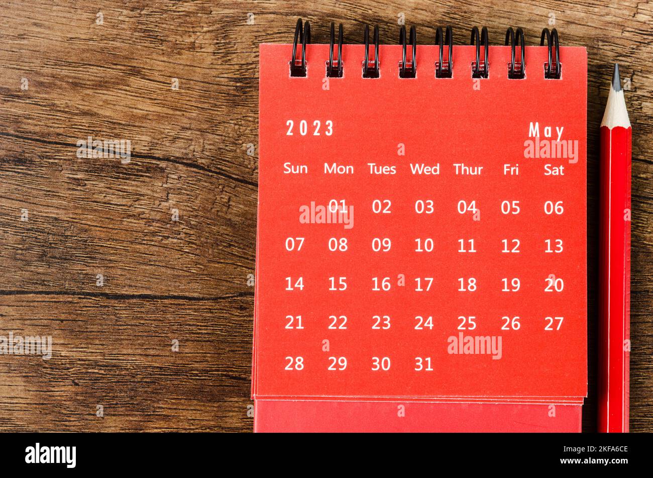 Red May 2023 Monthly desk calendar for 2023 year with pencil on wooden ...