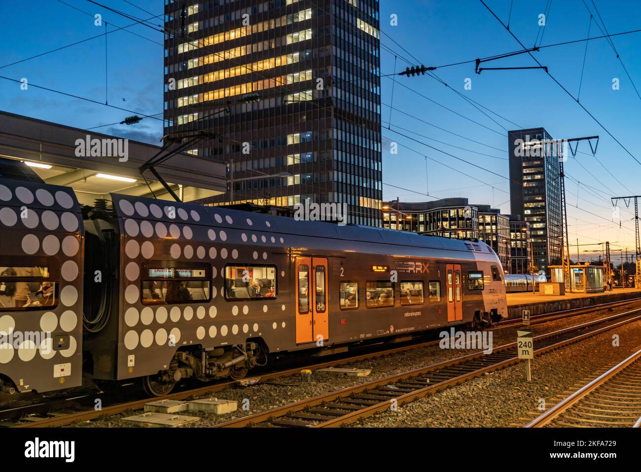 Train station, RRX regional express train on the platform, skyline of ...