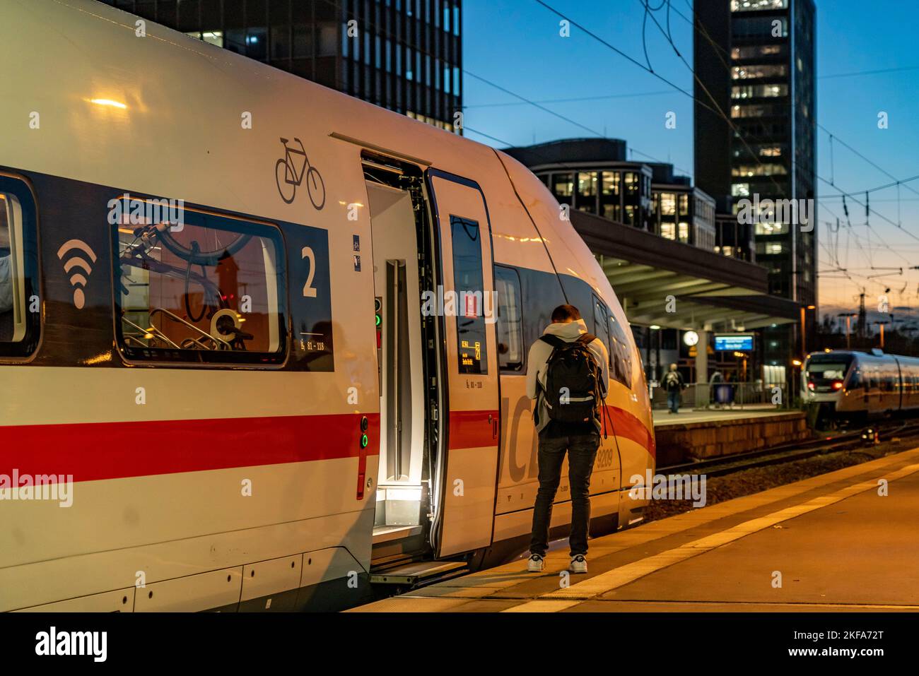 Railway station, ICE train on platform, skyline of Essen city centre ...