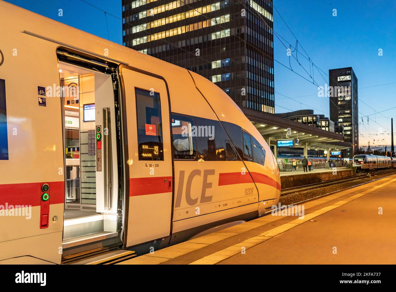 Railway station, ICE train on platform, skyline of Essen city centre ...