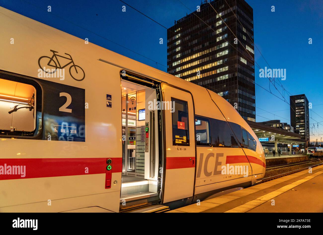 Railway station, ICE train on platform, skyline of Essen city centre ...
