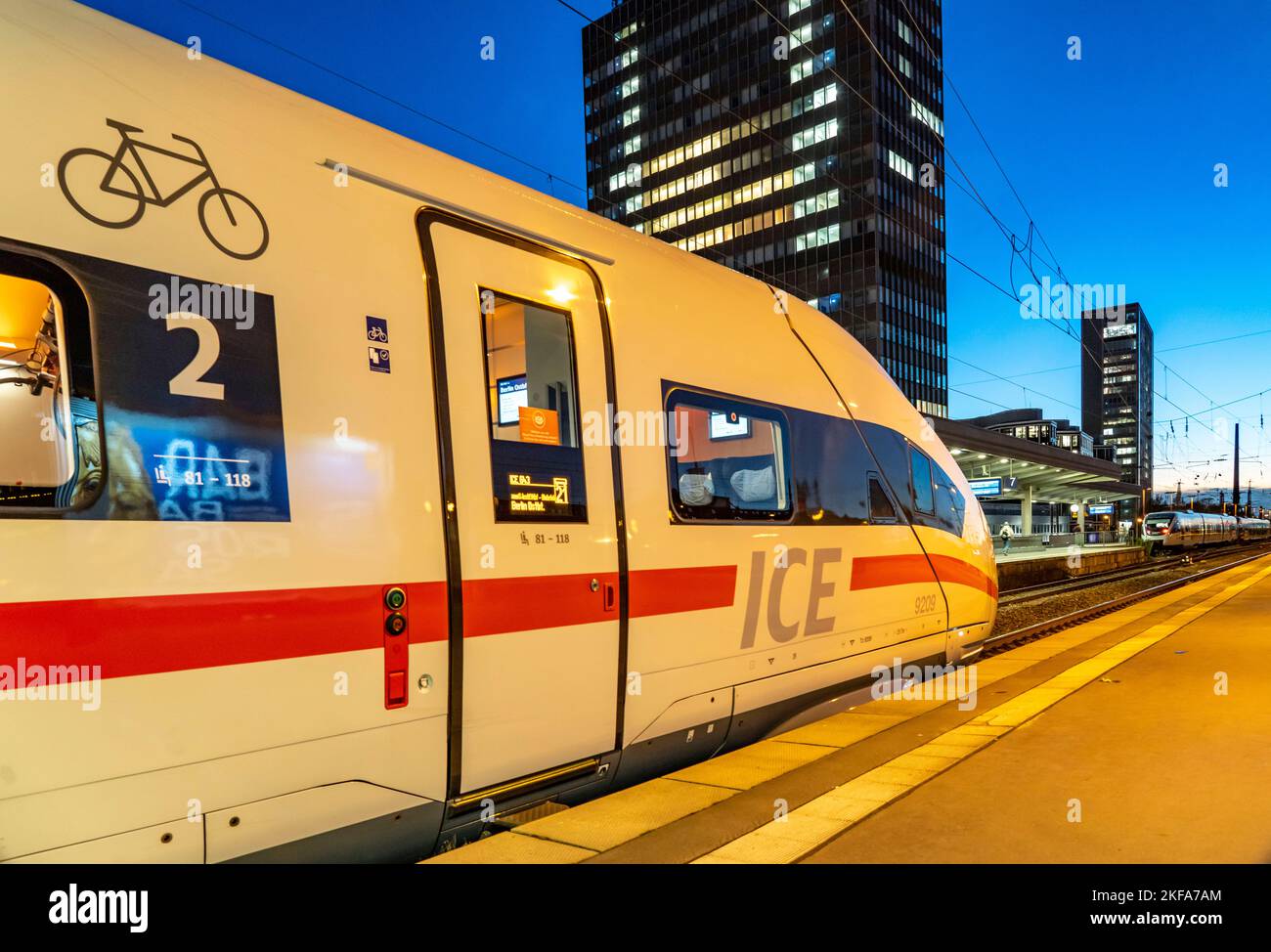 Railway station, ICE train on platform, skyline of Essen city centre ...