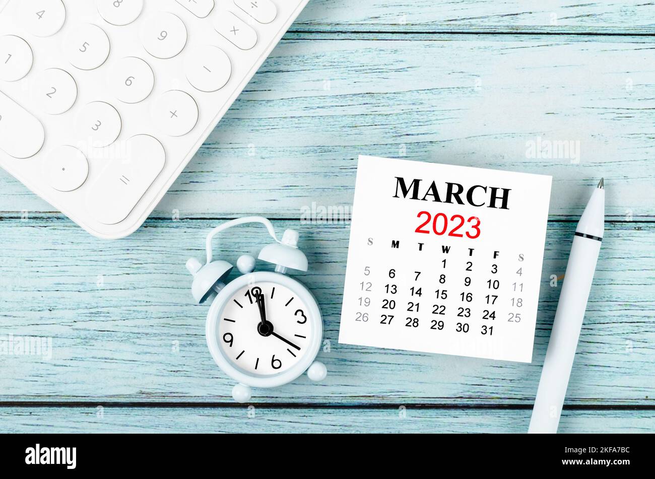 March 2023 Monthly calendar year and alarm clock with calculator on ...