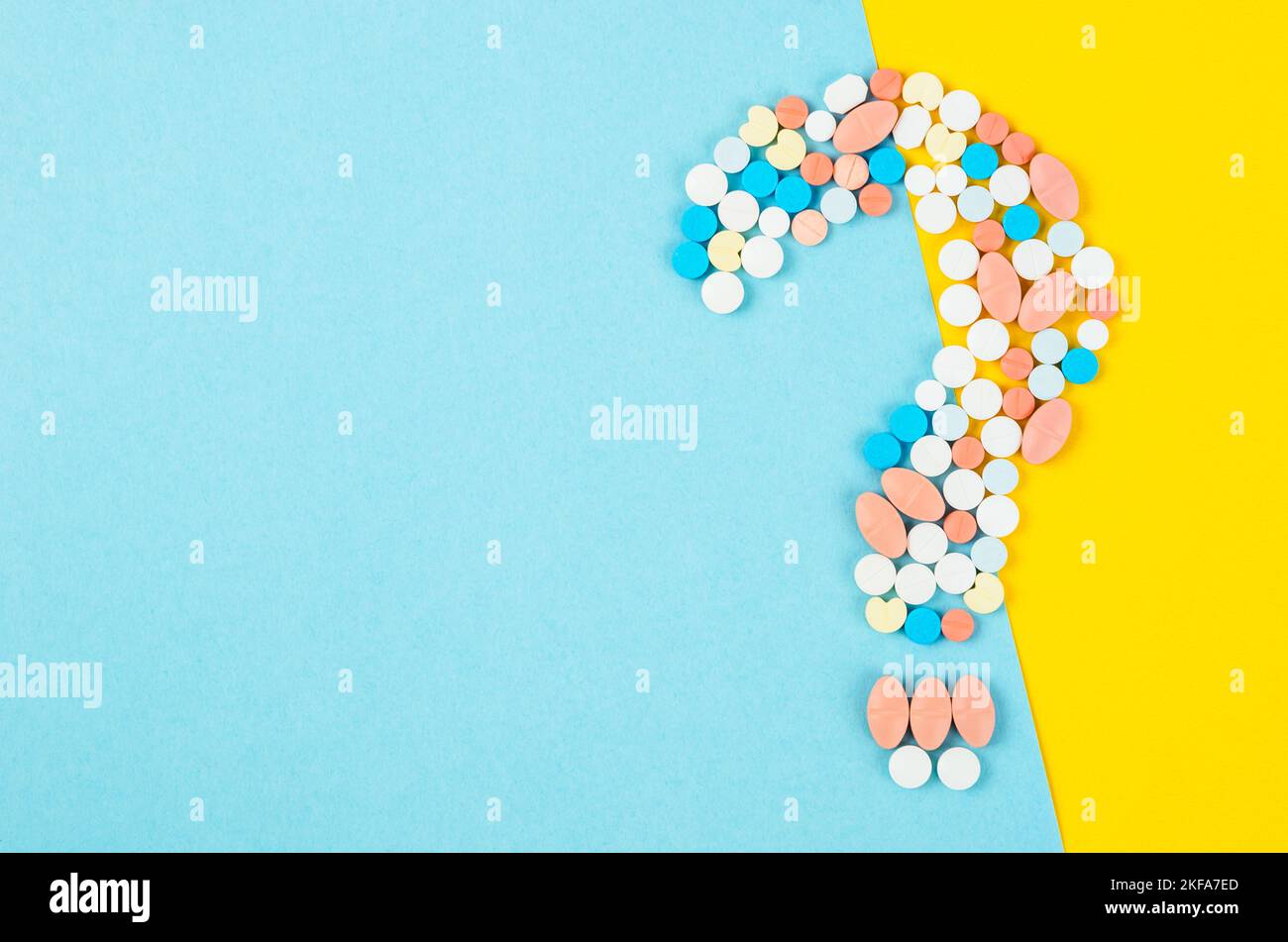 Question mark from laid out of medicine pills with bottle drug on blue ...