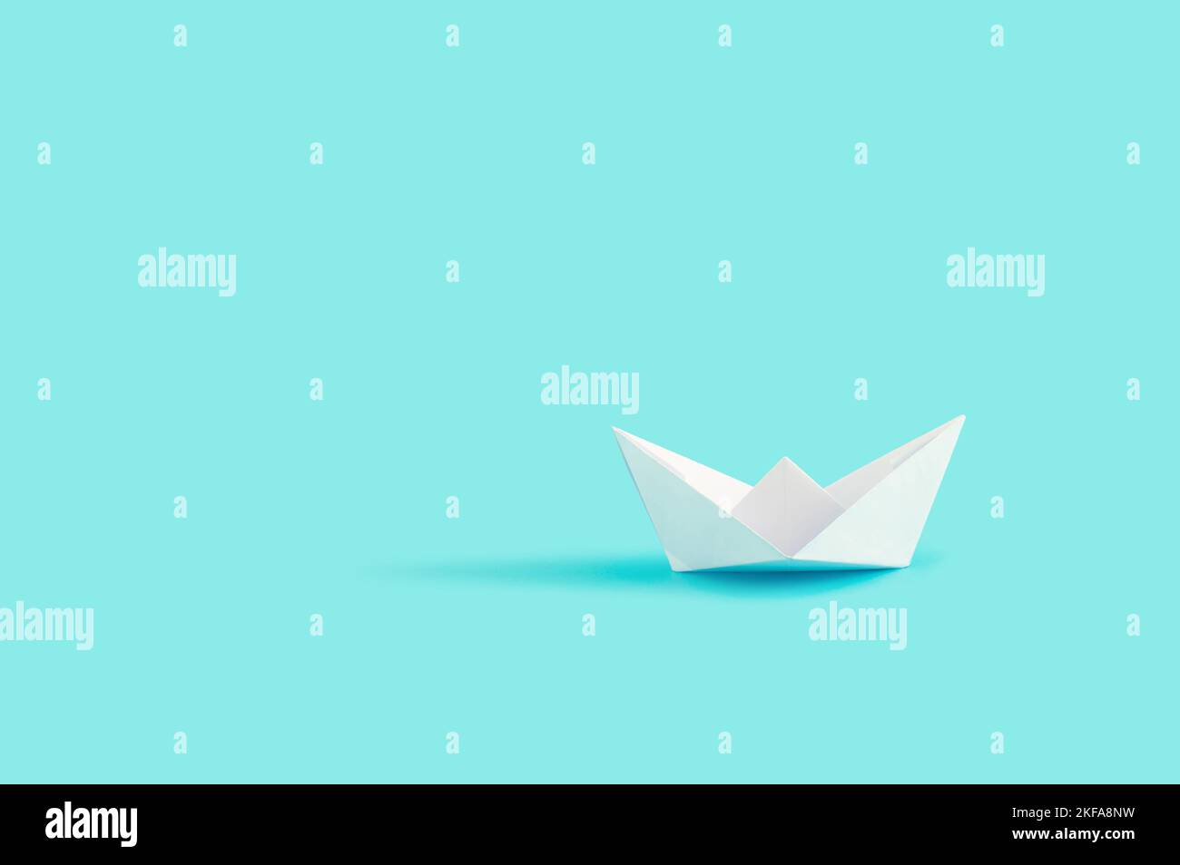 A closeup shot of a white paper boat on the blue background Stock Photo ...