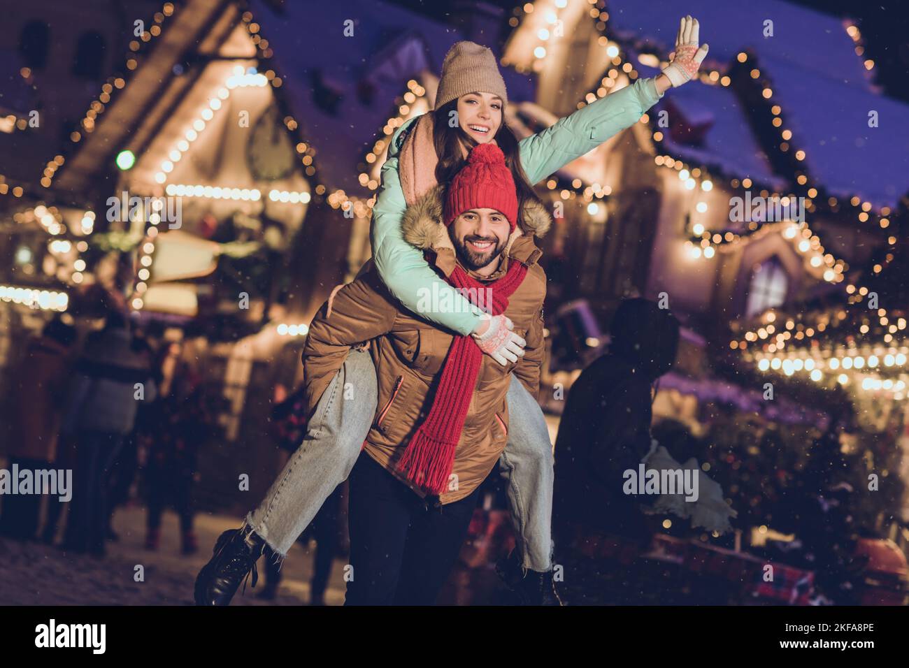 Photo of cool young couple piggyback wear cap jacket scarf gloves jeans ...