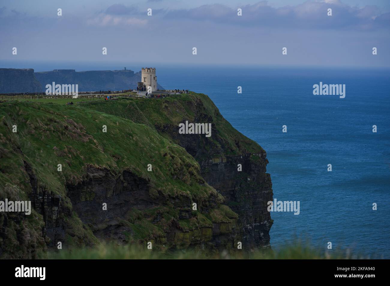 A beautiful shot of a single stone castle on the edge of a cliff near ...