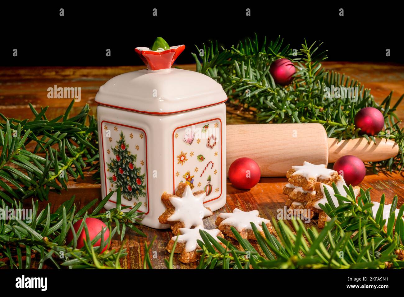Christmas scene with cinnamon stars, rolling pin, a ceramic biscuit tin ...