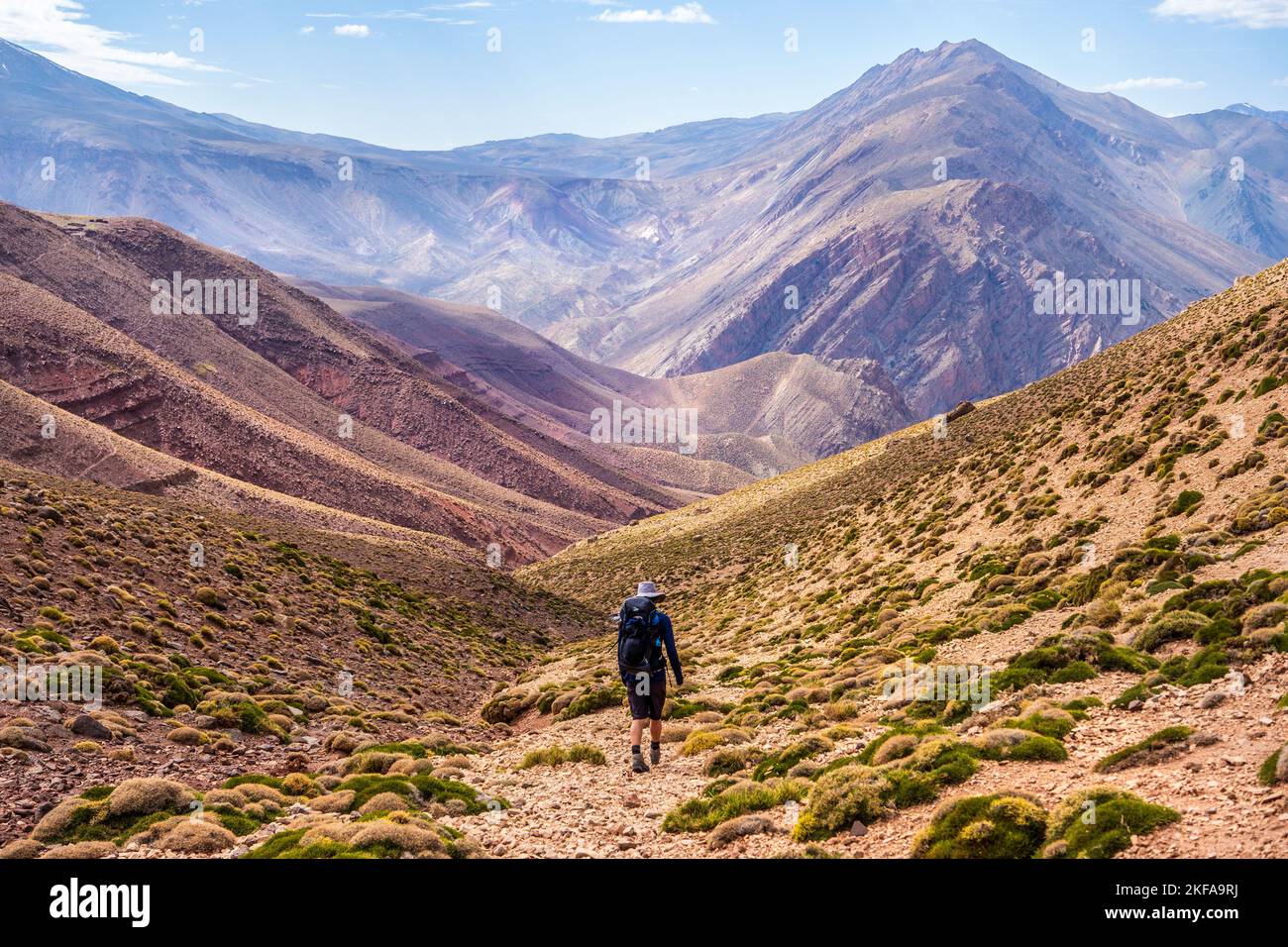 Young male trekker hiking in the M'Goun region of the High Atlas ...